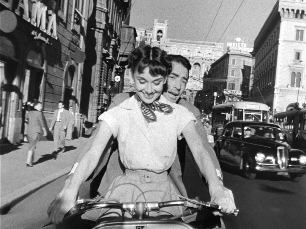 1200px-Audrey_Hepburn_and_Gregory_Peck_on_Vespa_in_Roman_Holiday ...